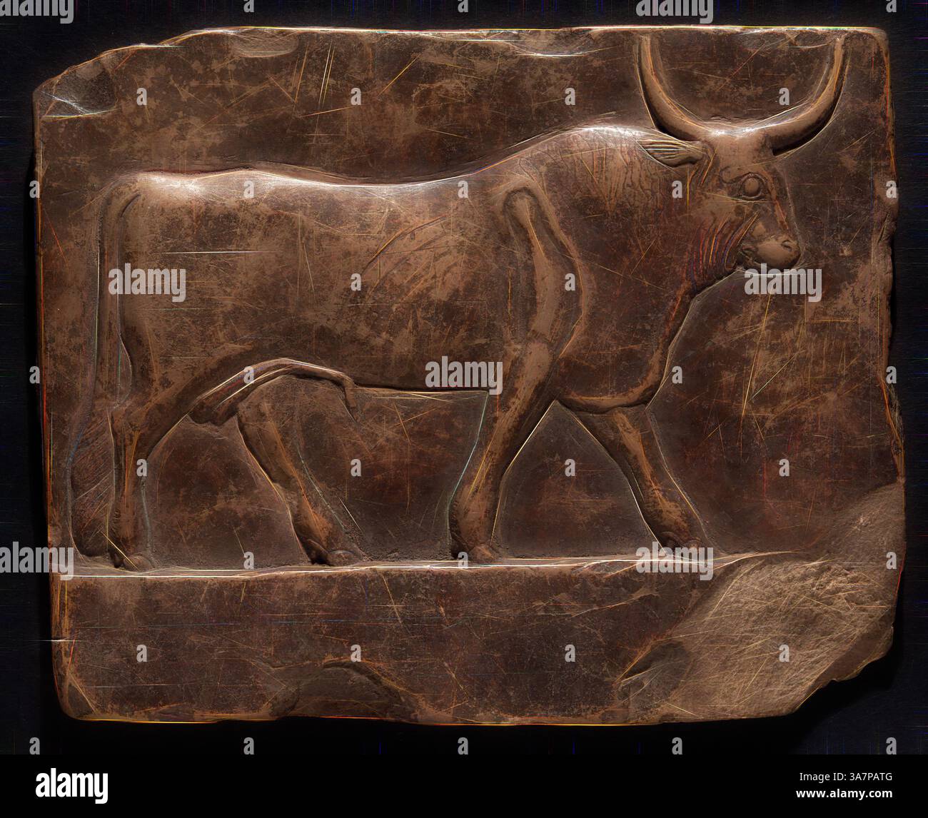A finely detailed relief carving of a bull, showcasing its robust form ...