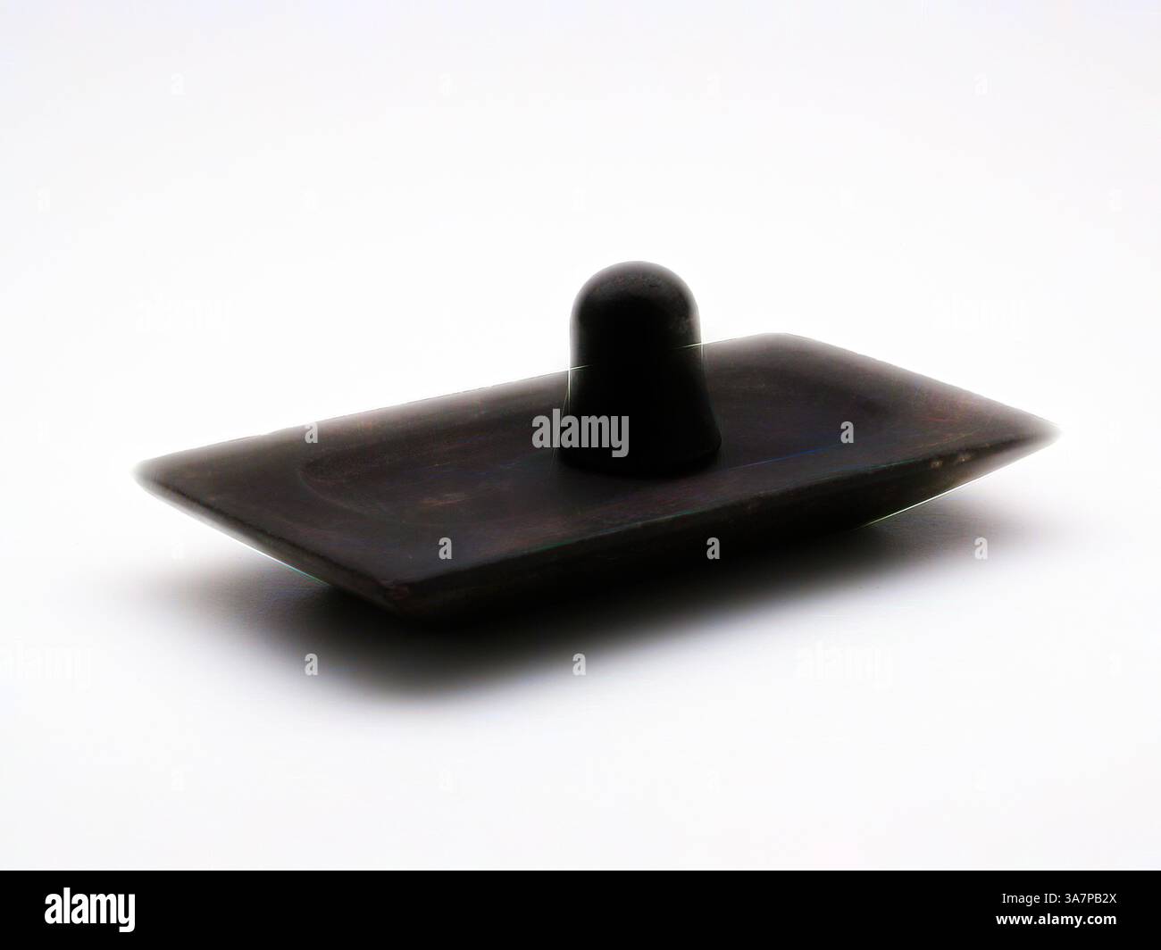 A sleek, geometric object featuring a flat rectangular base with a ...