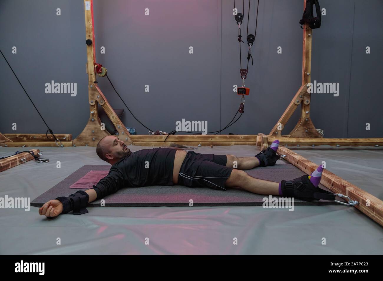 Caucasian man lying on a mat, undergoing spinal decompression therapy ...