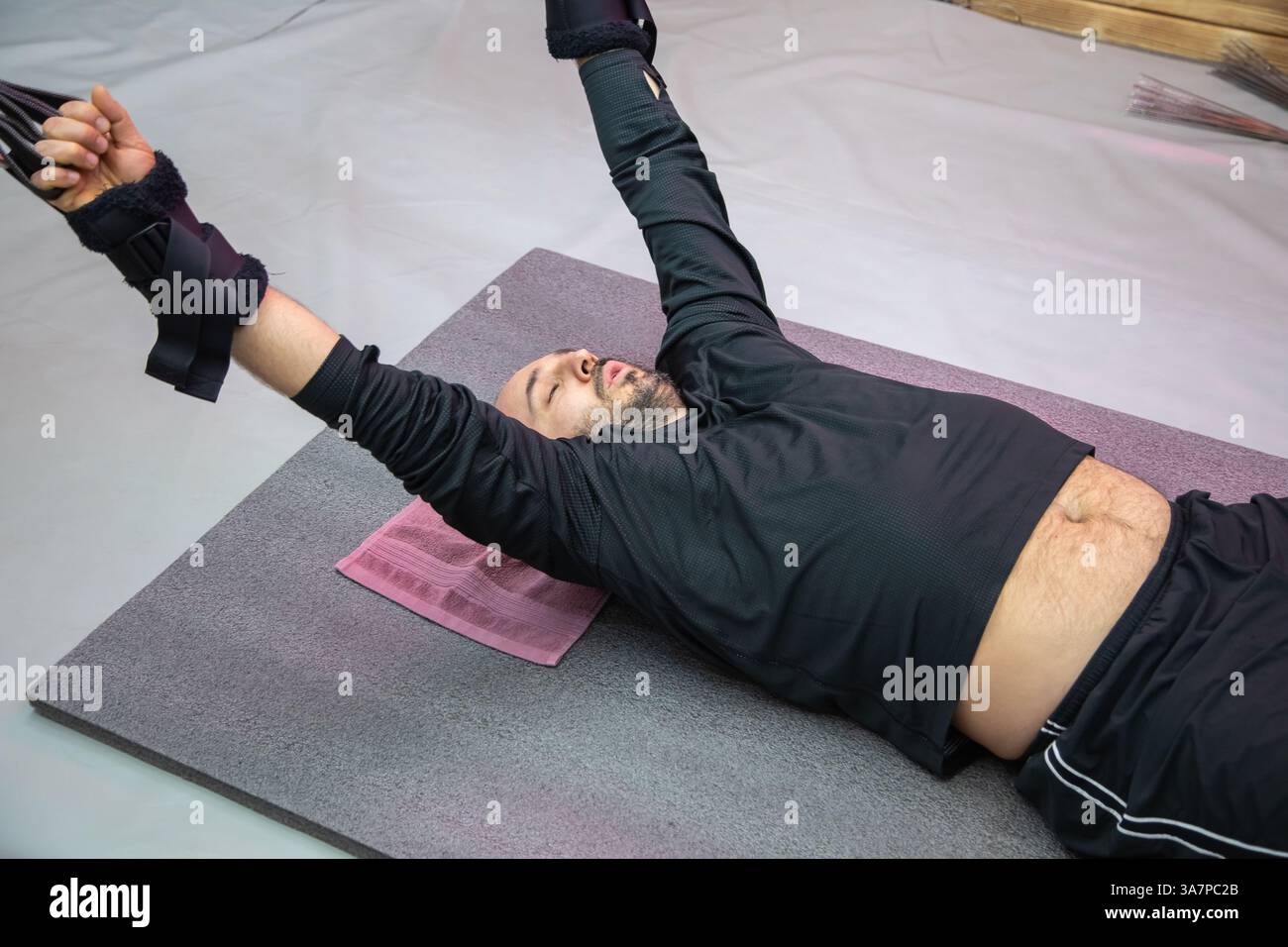 Athlete performing a suspension training exercise, strengthening his ...