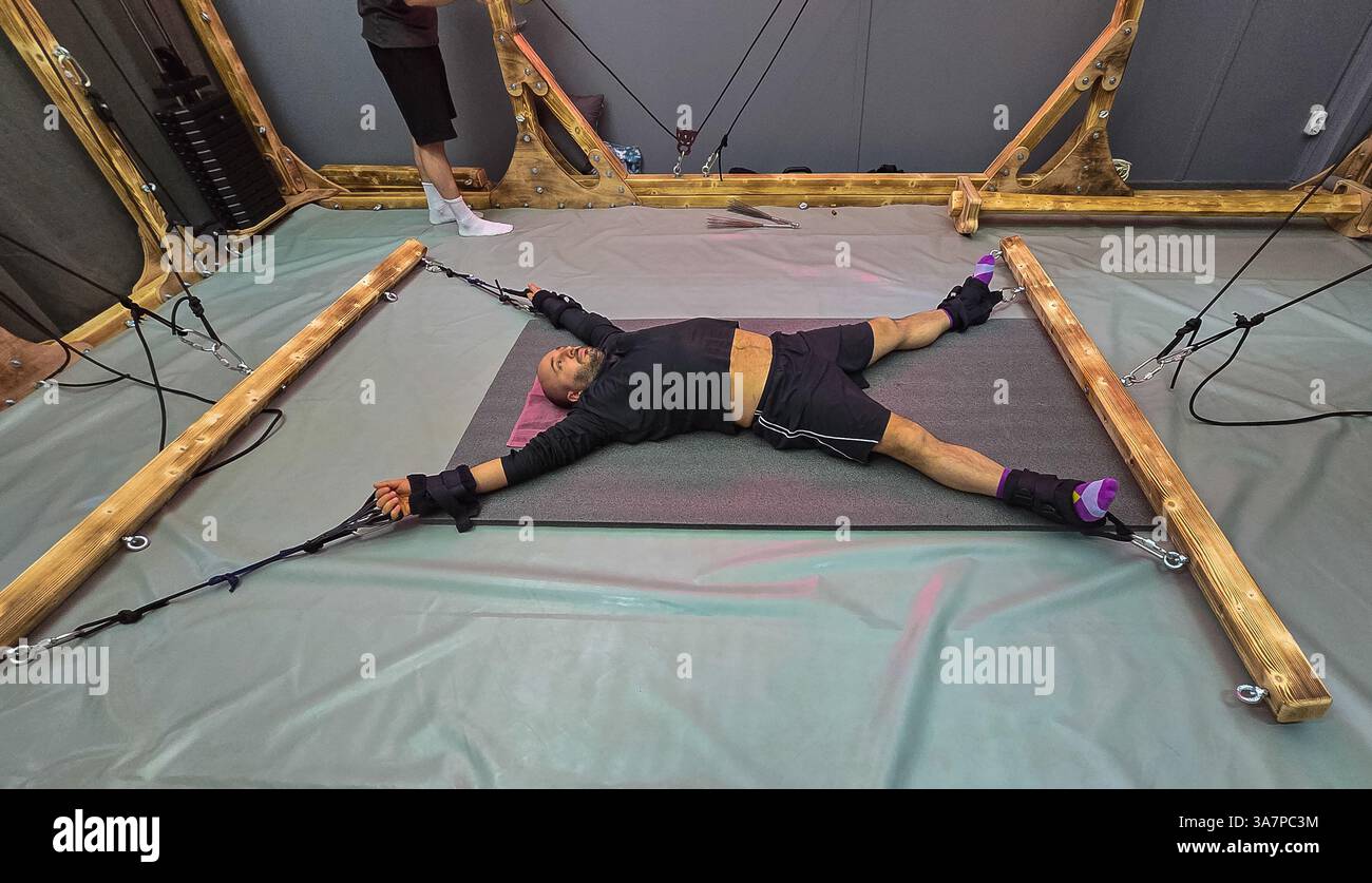 Athlete exercising with suspension training system in modern gym Stock ...