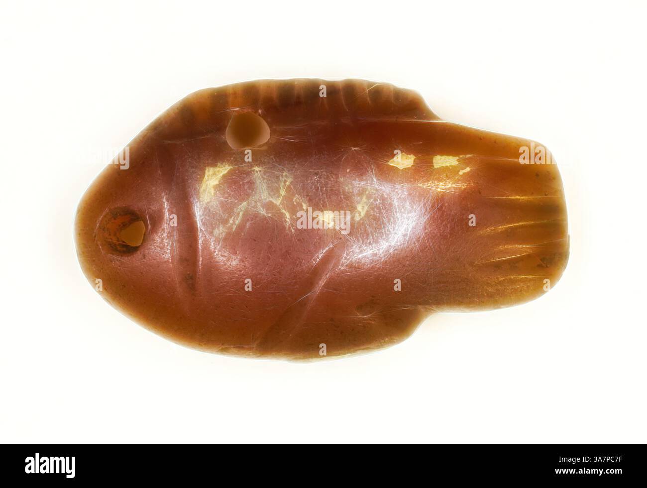 A beautifully carved artifact resembling a fish, showcasing intricate ...