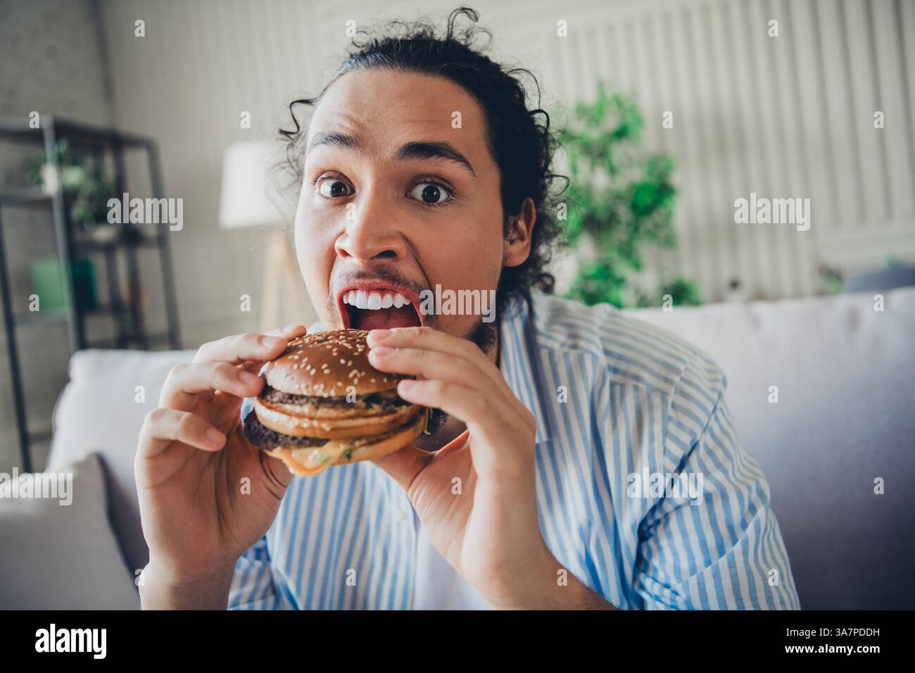 Hungry young man excitedly hi-res stock photography and images - Alamy
