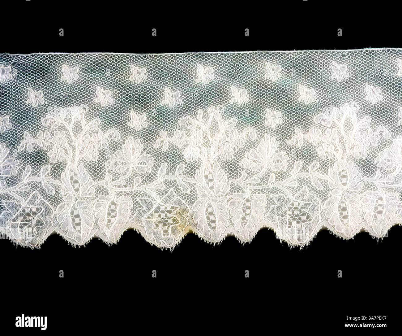 A delicate lace trim featuring intricate floral patterns and elegant ...