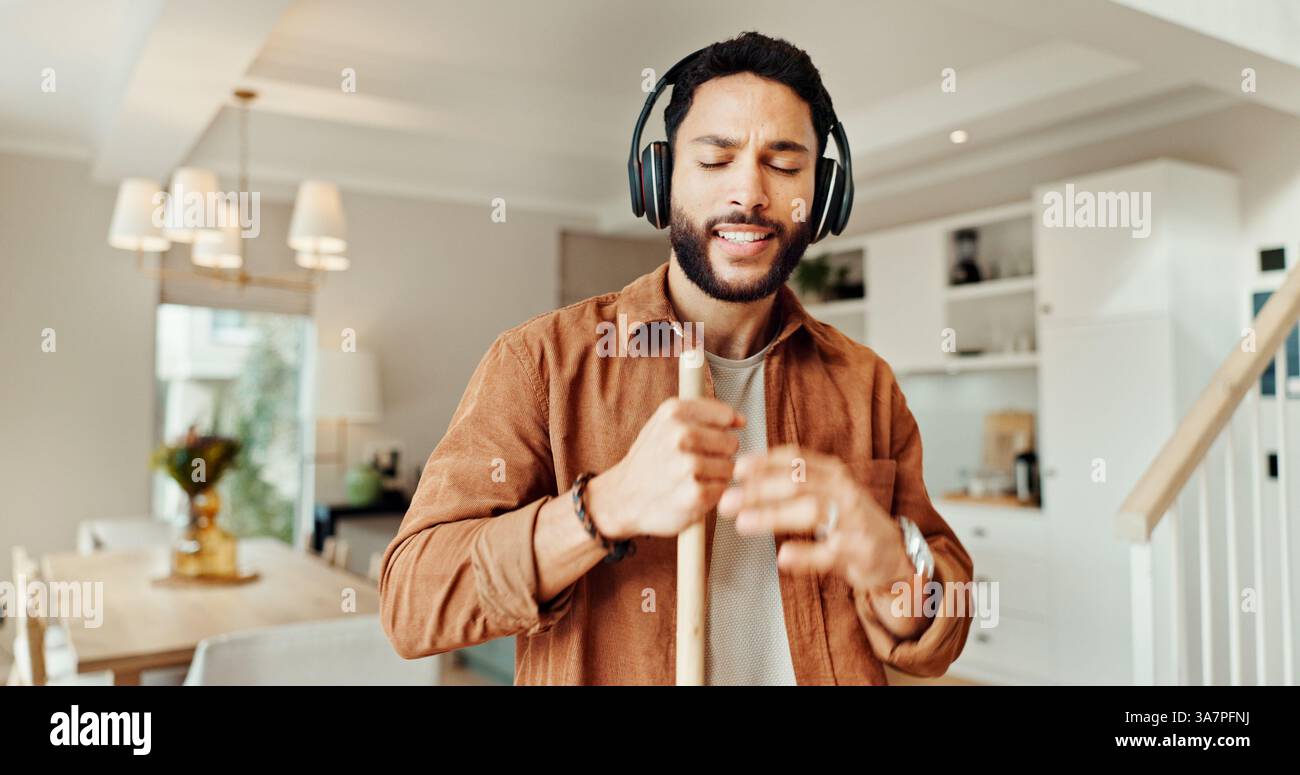 Music, sing and sweeping with man in home for chores, responsibility or ...