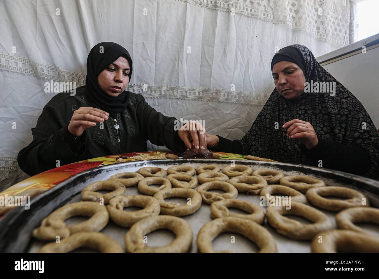 Palestinian families prepare the traditional cookies ahead of Eid al ...