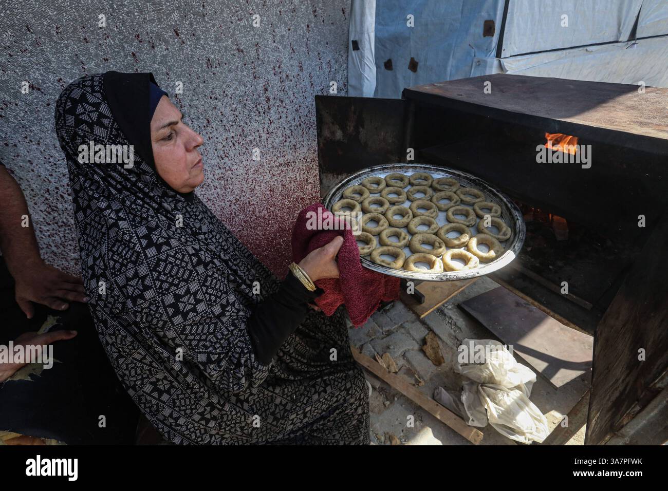 Palestinian families prepare the traditional cookies ahead of Eid al ...