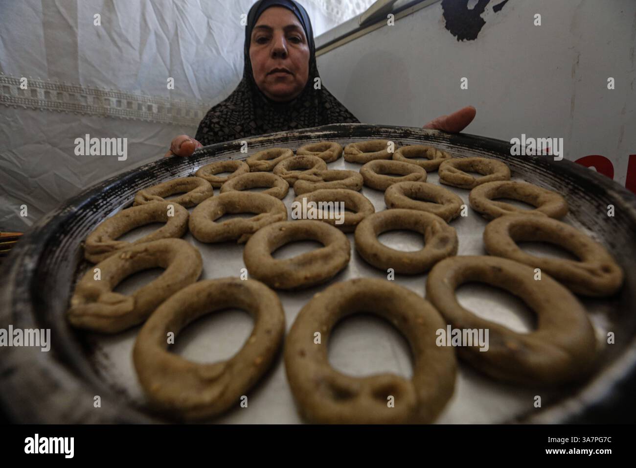 Palestinian families prepare the traditional cookies ahead of Eid al ...