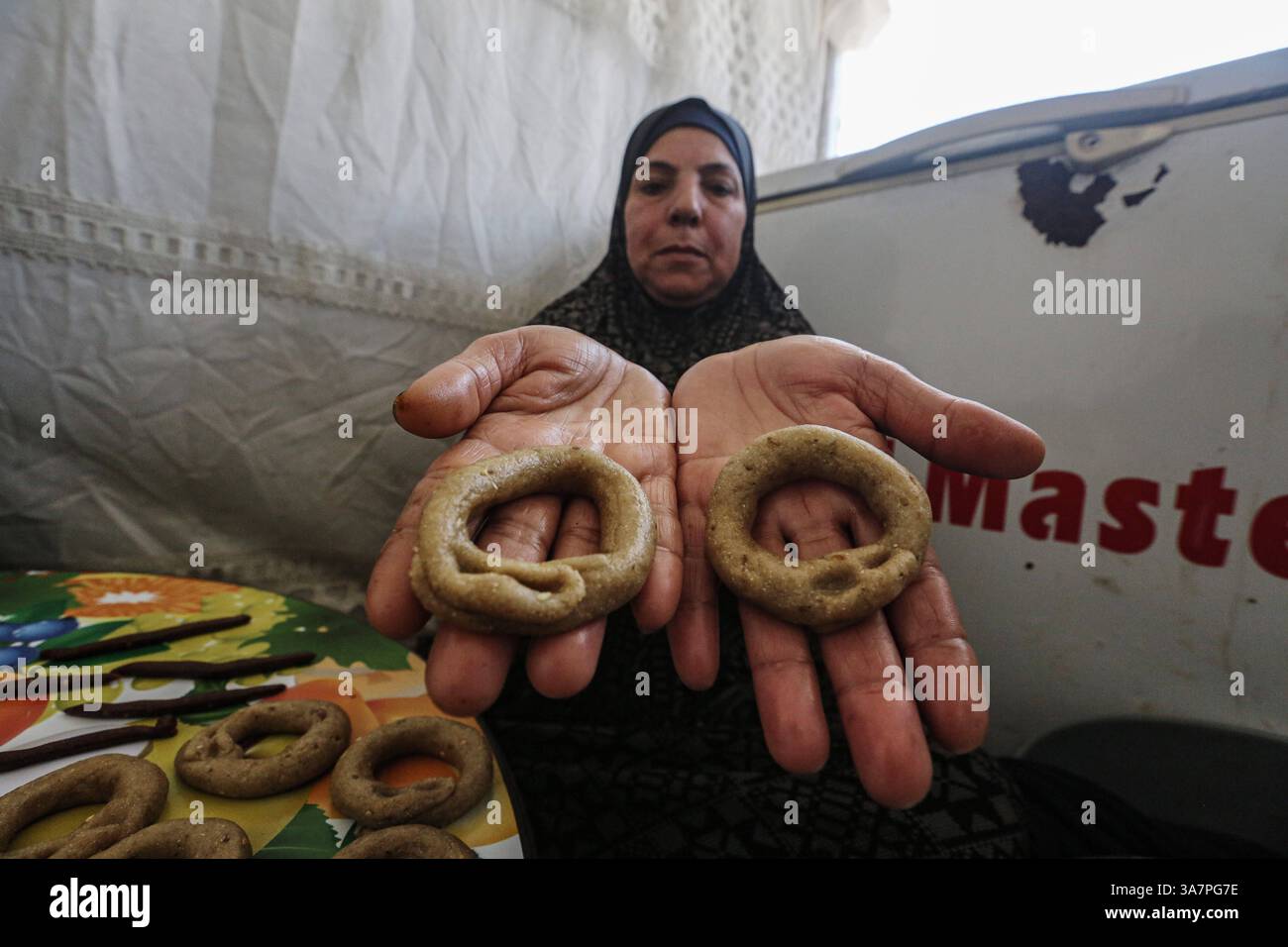 Palestinian families prepare the traditional cookies ahead of Eid al ...