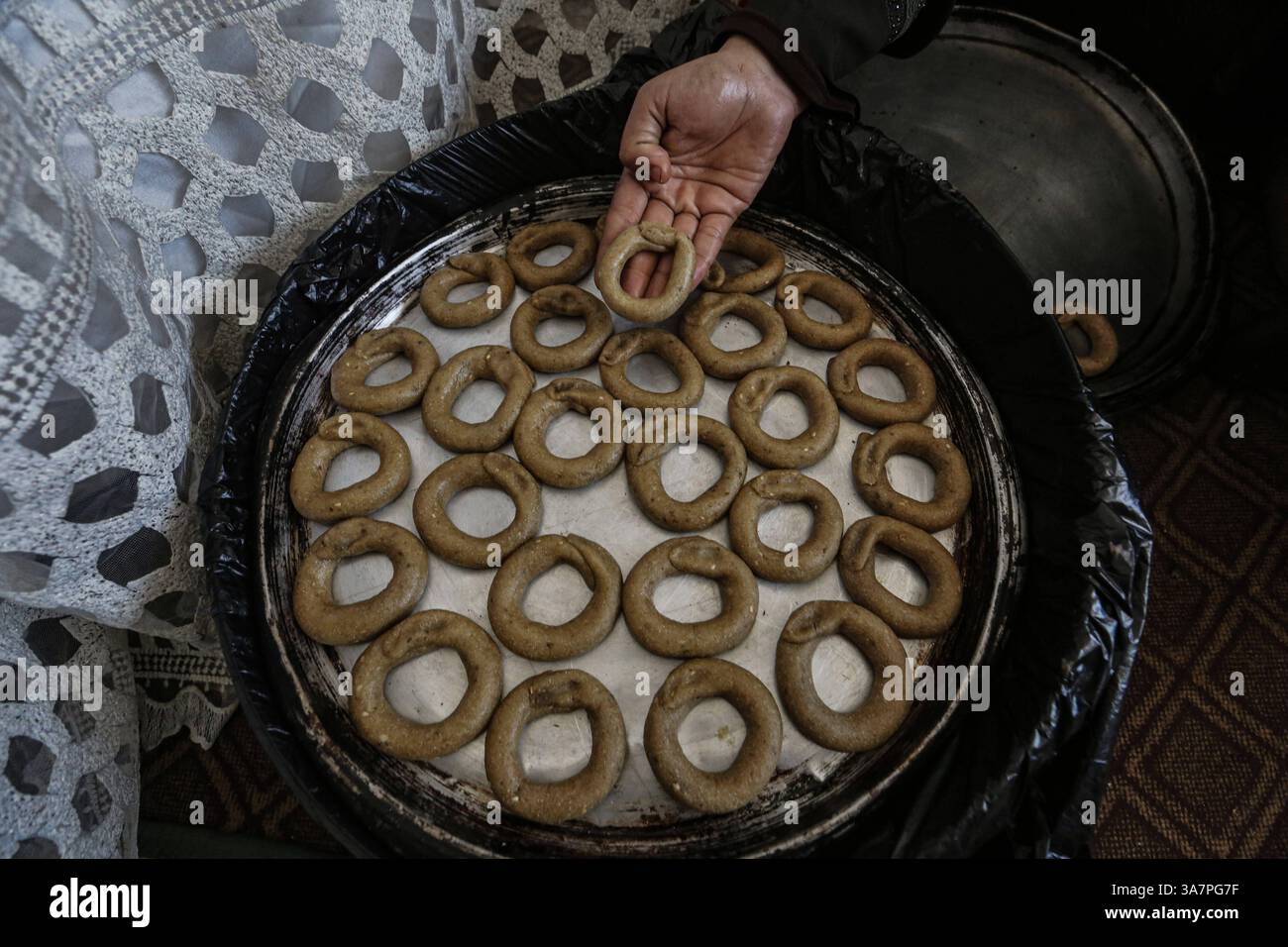 Palestinian families prepare the traditional cookies ahead of Eid al ...