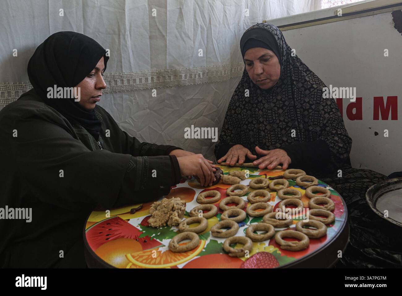 Palestinian families prepare the traditional cookies ahead of Eid al ...