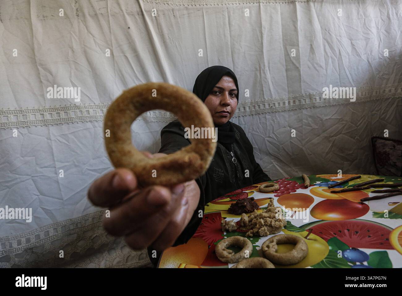 Palestinian families prepare the traditional cookies ahead of Eid al ...