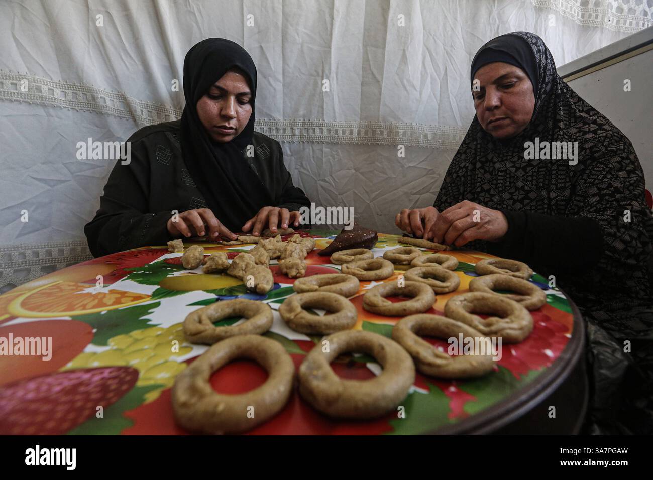 Palestinian families prepare the traditional cookies ahead of Eid al ...