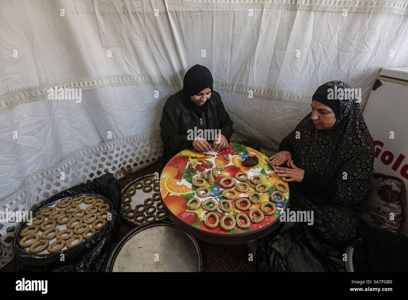 Palestinian families prepare the traditional cookies ahead of Eid al ...