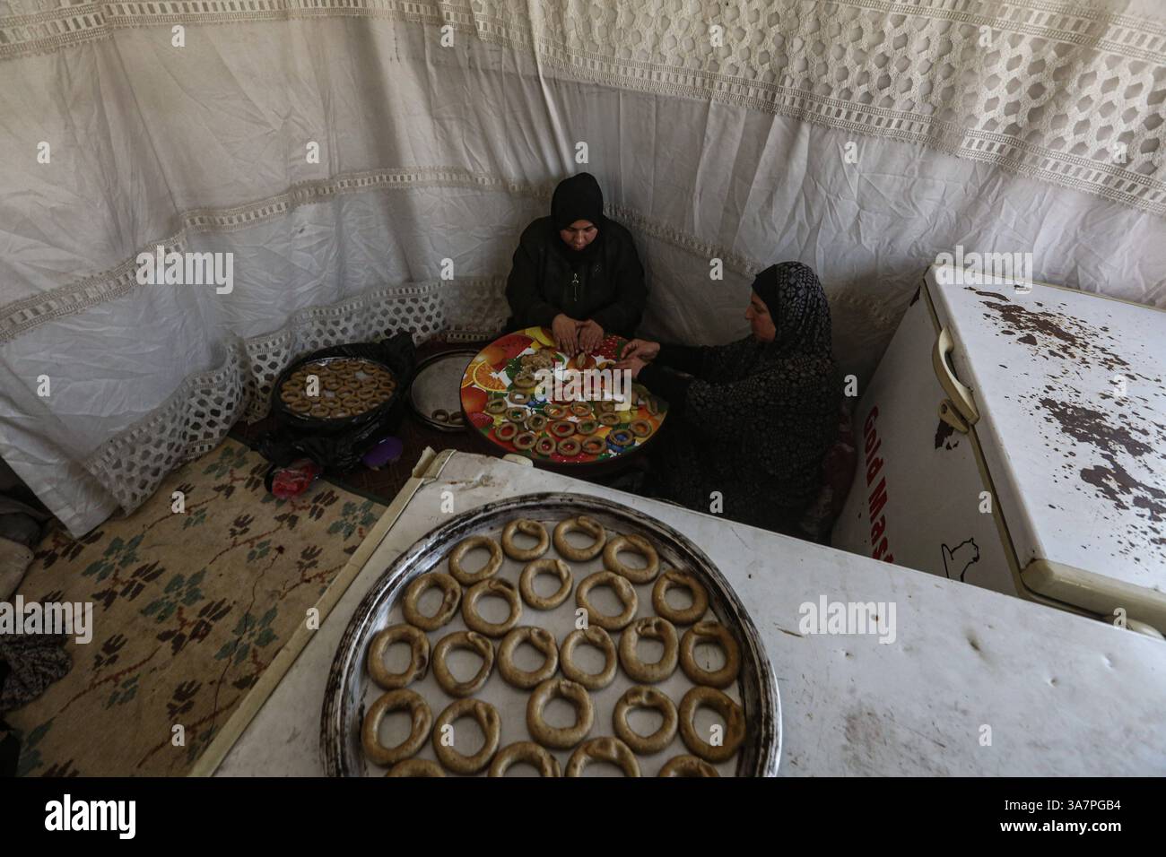 Palestinian families prepare the traditional cookies ahead of Eid al ...