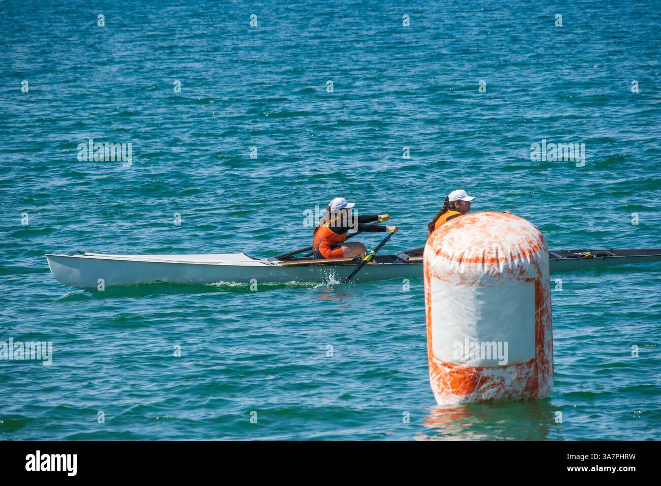 Rowing Pair Near Sporfest Buoy in Fethiye: Two individuals row a double ...