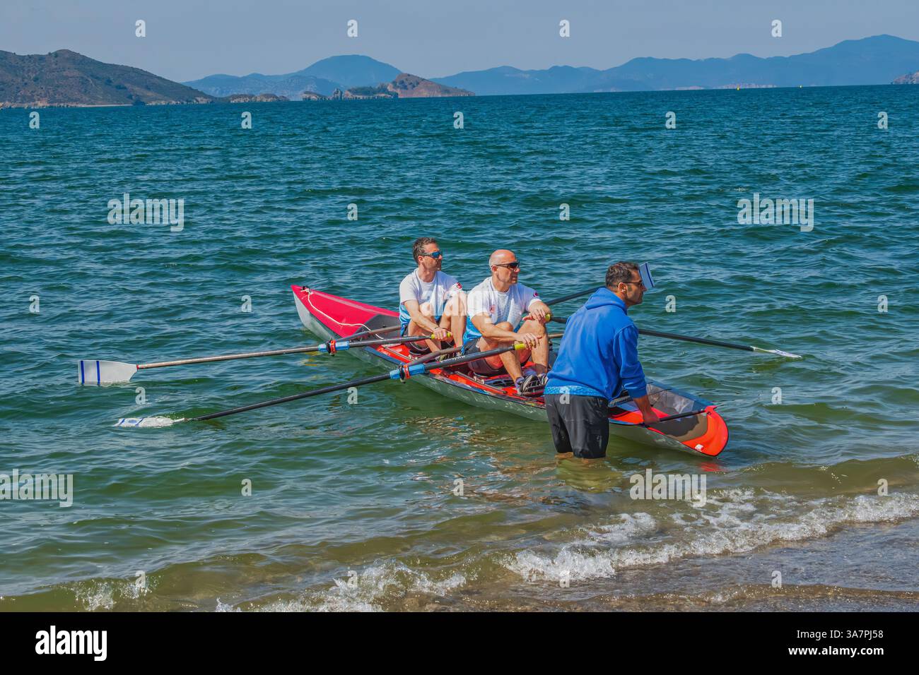 Rowing team arriving at shore with support after a water race ...