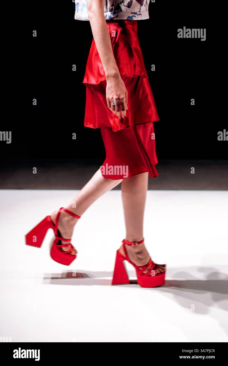 Bright red skirt and high heels shoes on a female figure, stylish ...