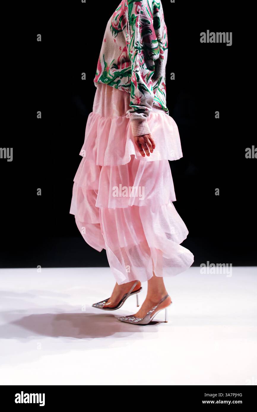 Pink airy skirt and fashionable sweater on a female figure, stylish ...