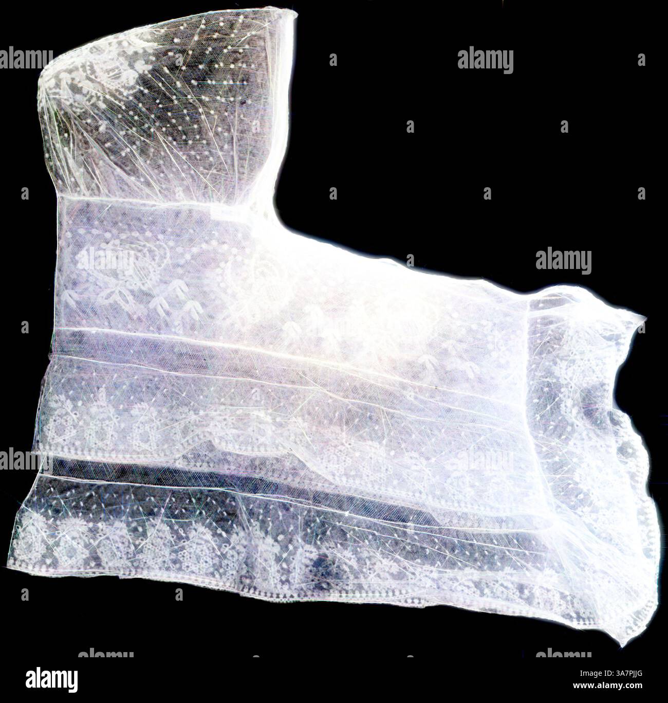 An intricately patterned lace fabric forms a delicate and ethereal ...