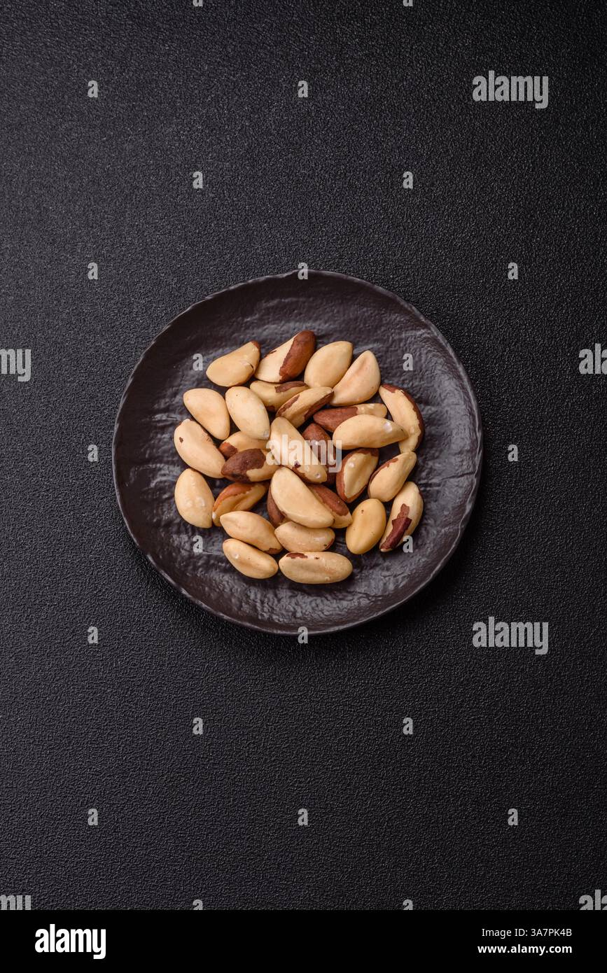 Brazil nut kernels in ceramic bowl on dark concrete background Stock ...