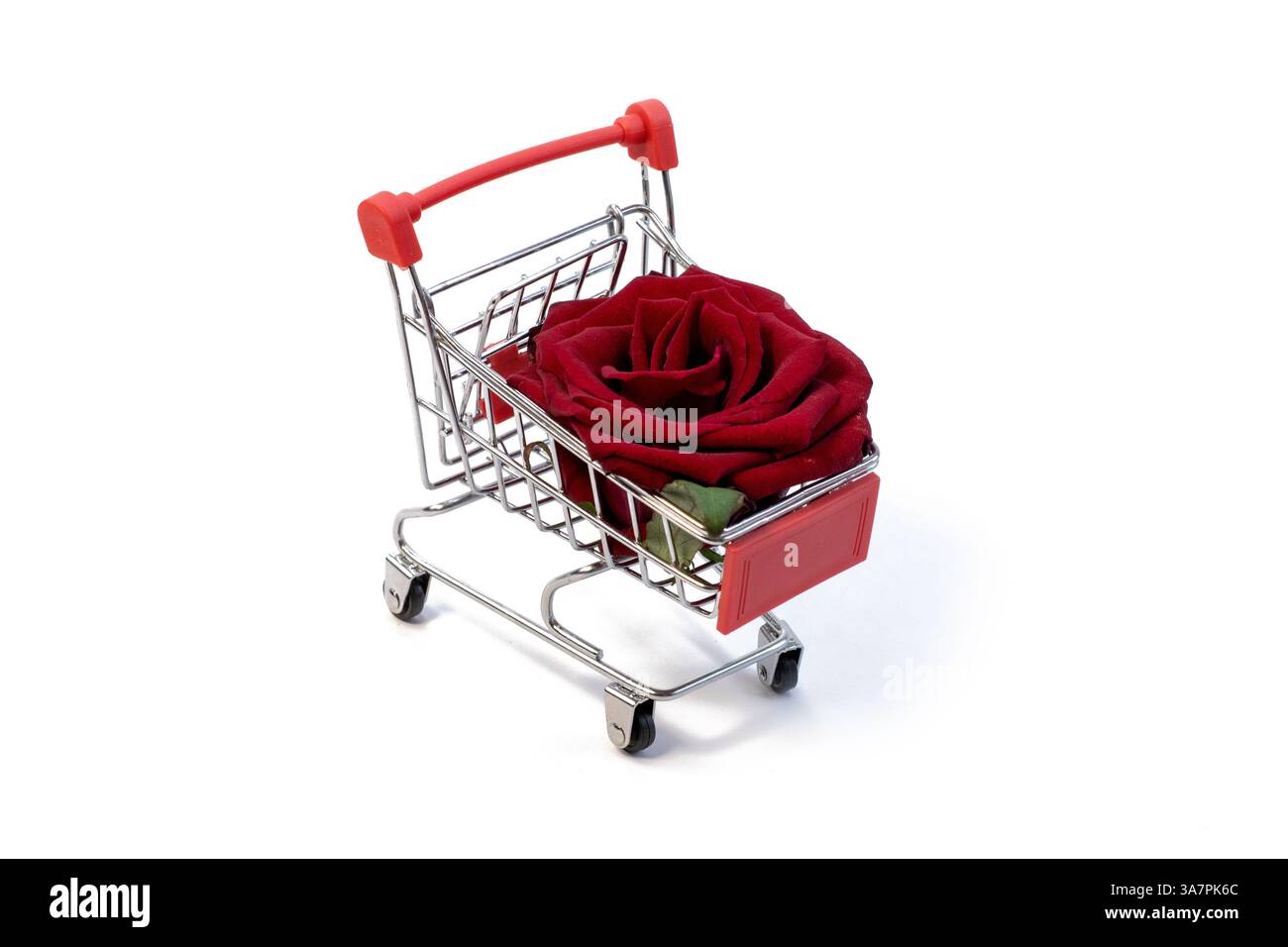 Small miniature supermarket trolley on light background, close up with ...