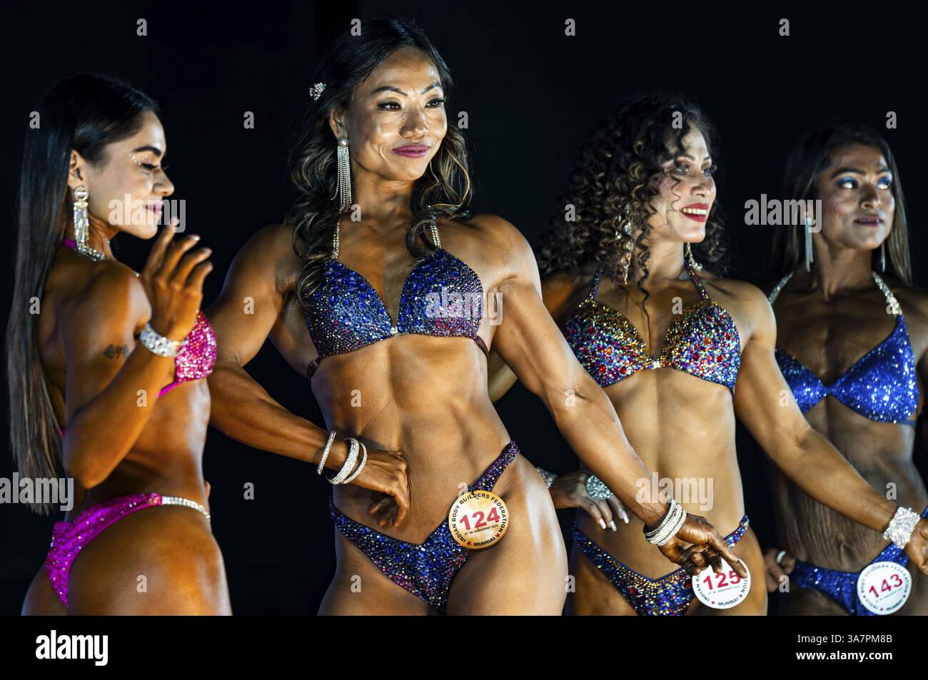 Female bodybuilders pose on stage as they compete the 4th Ms Saraighat all India classic body ...