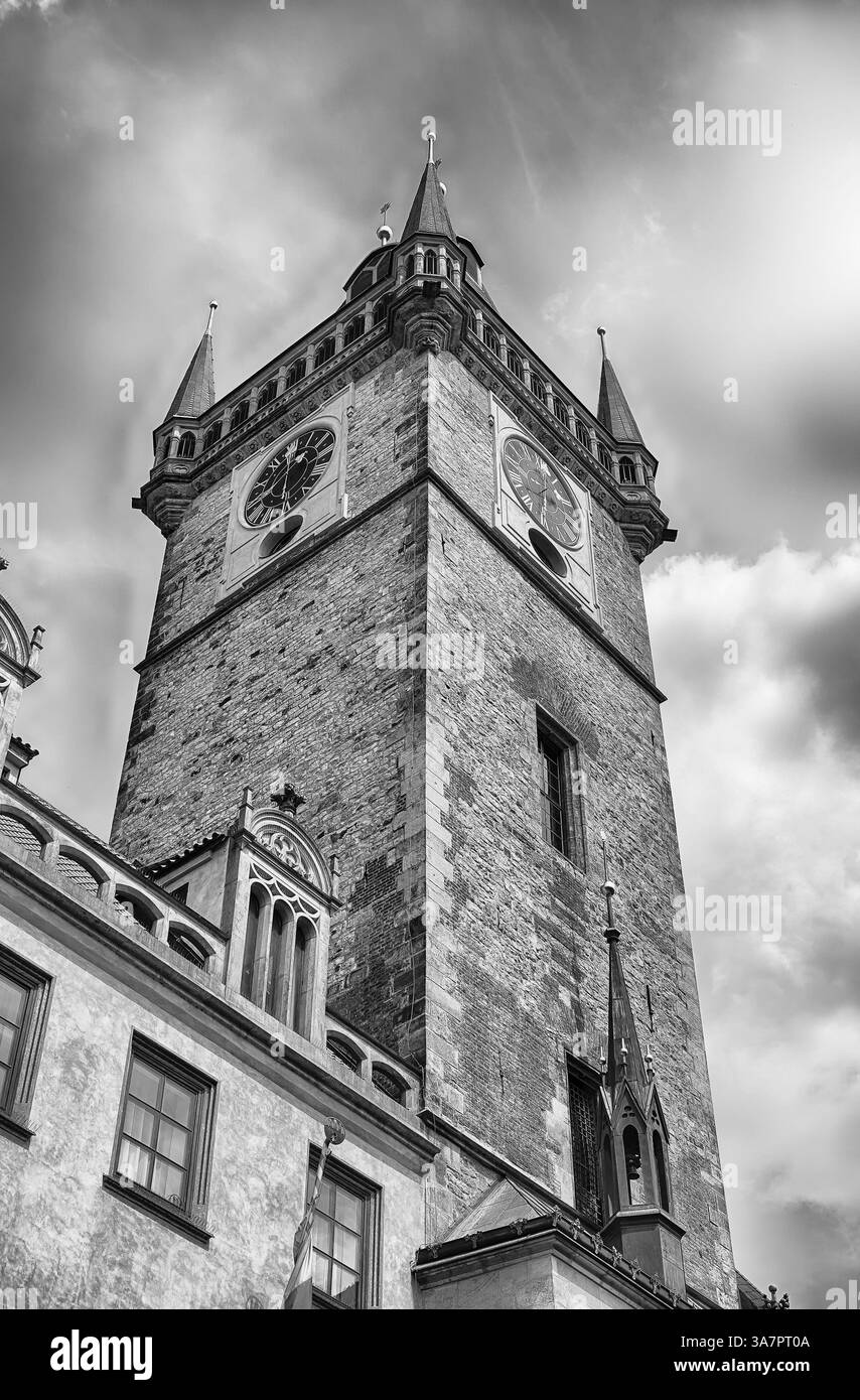 The old town hall tower standing tall against a bright blue sky, a symbol of Prague's rich ...