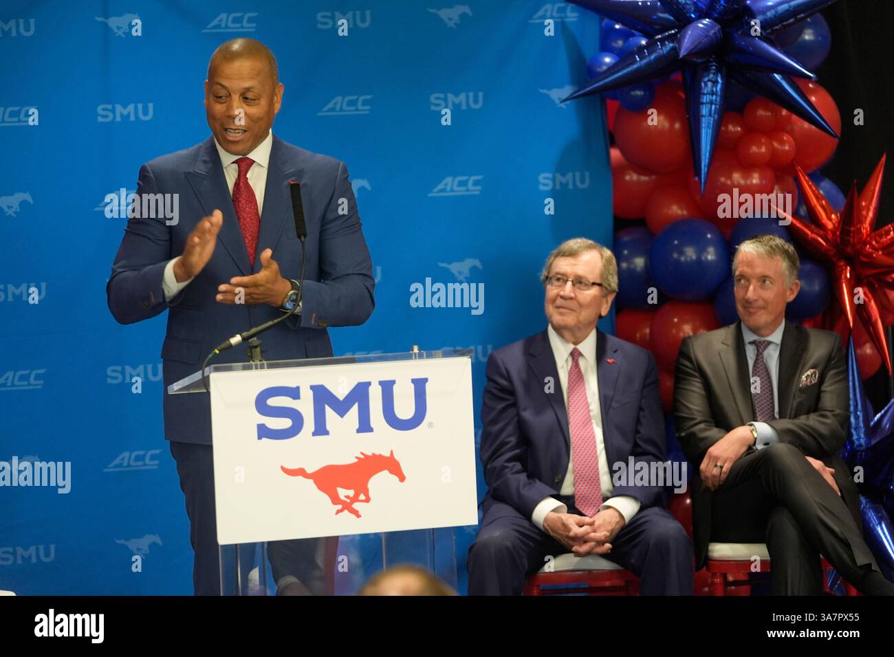 SMU athletic director Damon Evans speaks as SMU incoming president Jay Hartzell, right, and ...