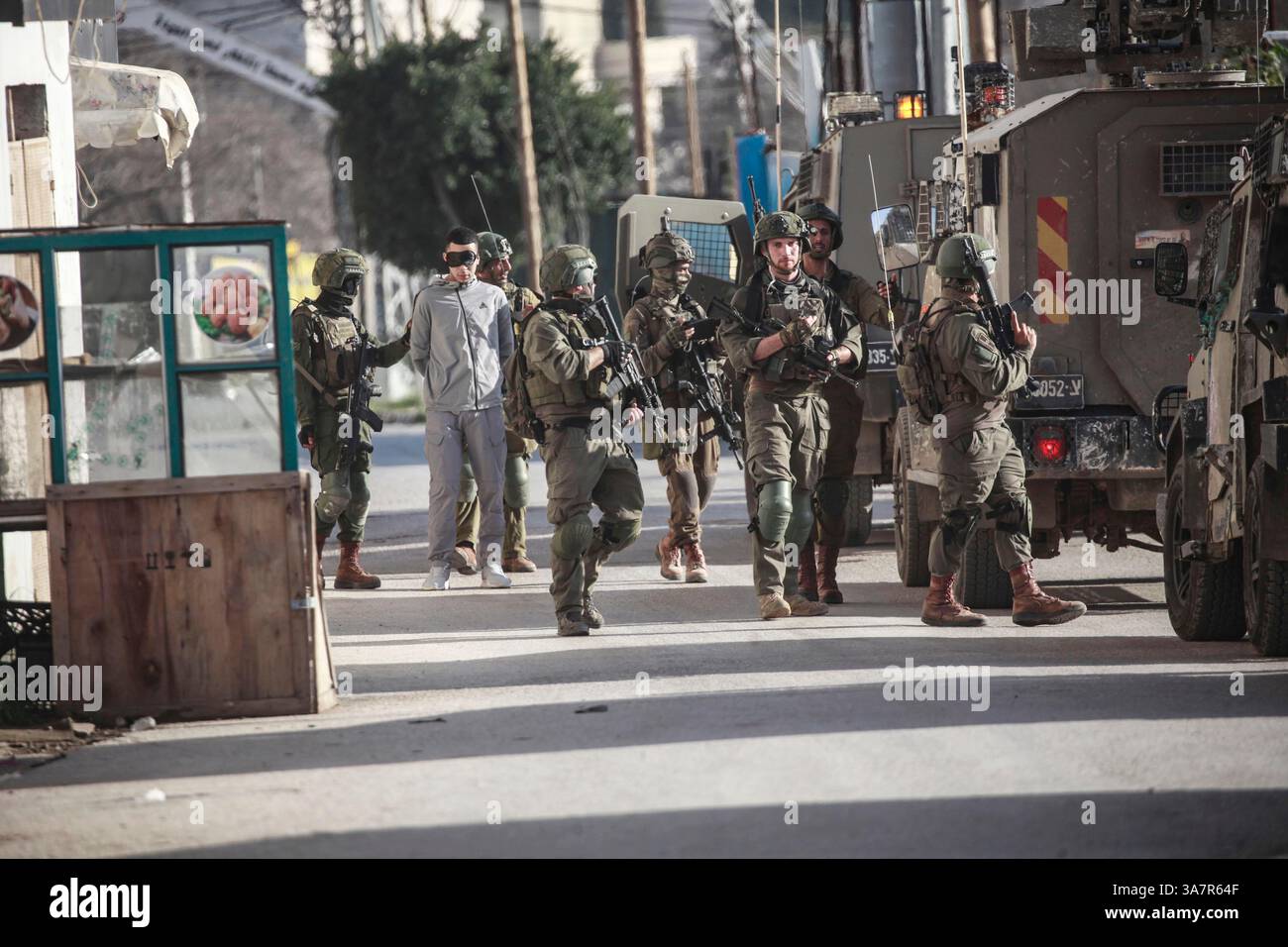 Nablus, Palestine. 27th Mar, 2025. Israeli soldiers arrest a ...