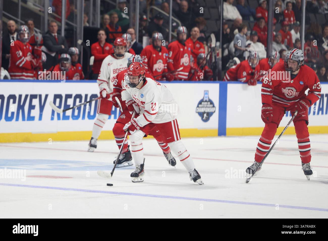 Boston University's Jack Harvey (12) skates with the puck against Ohio ...