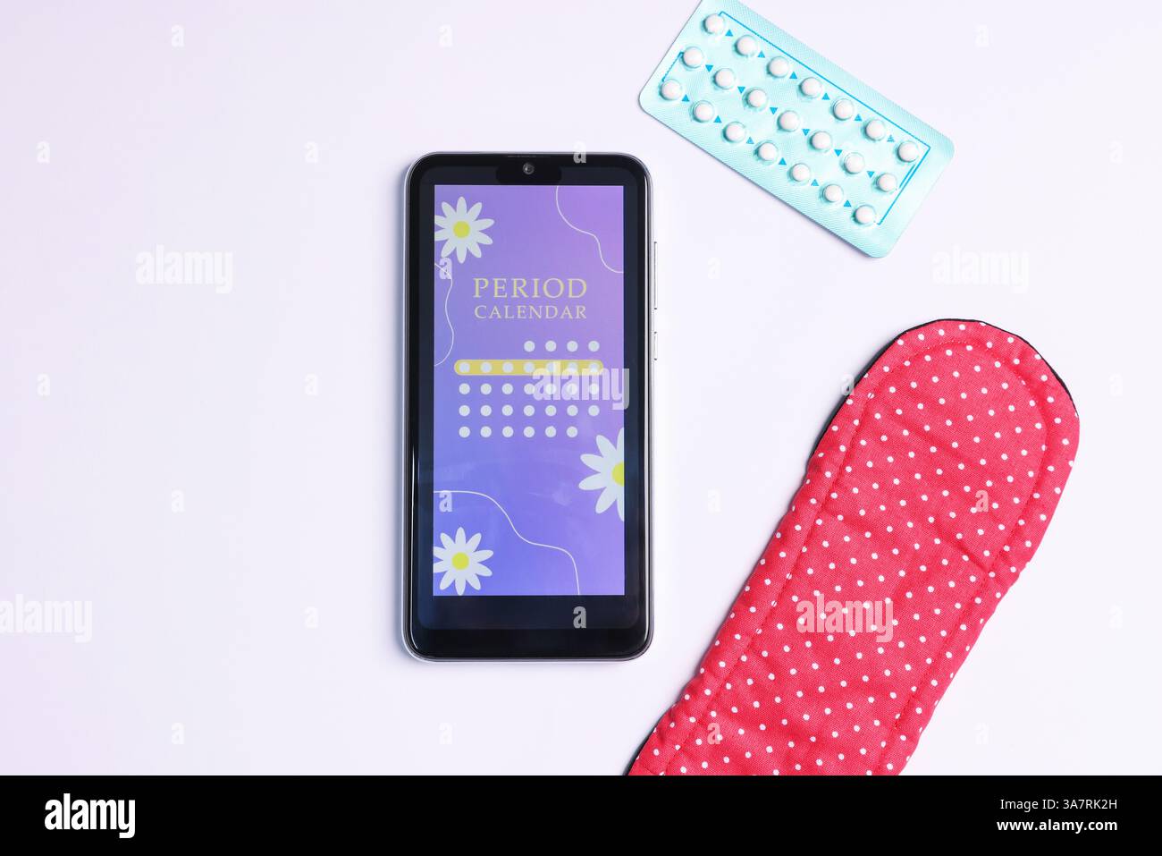 Smartphone with period calendar application and menstrual products on white background, flat lay ...