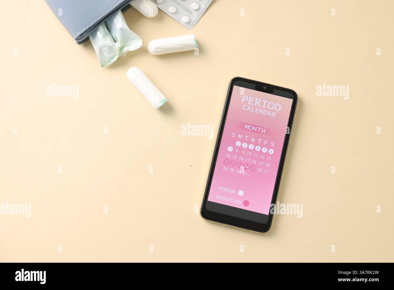 Smartphone with period calendar application and menstrual products on beige background, flat lay ...