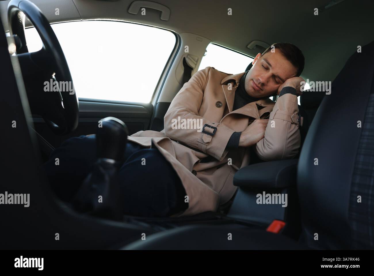 Tired driver sleeping in his modern car Stock Photo - Alamy