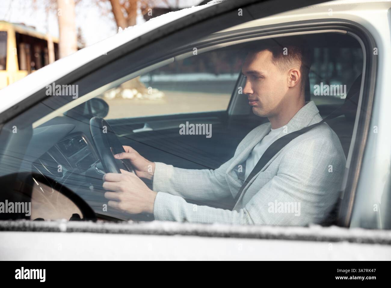 Driver behind steering wheel of modern car, view from outside Stock ...