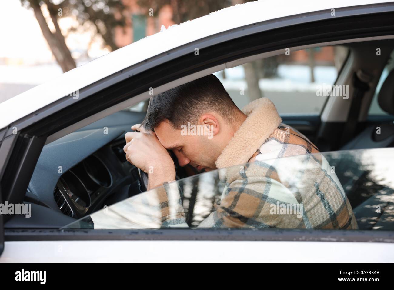 Tired driver sleeping on steering wheel in car, view from outside Stock ...