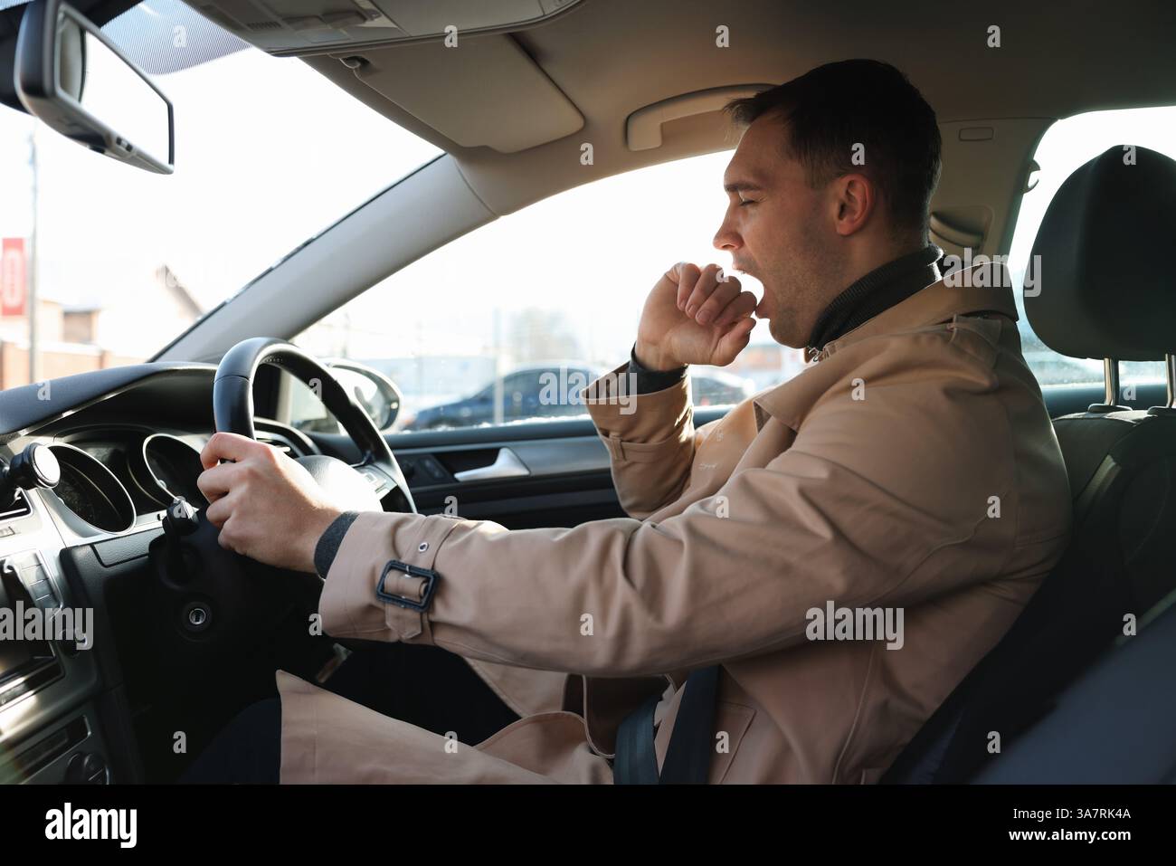 Sleepy driver yawning in his modern car Stock Photo - Alamy