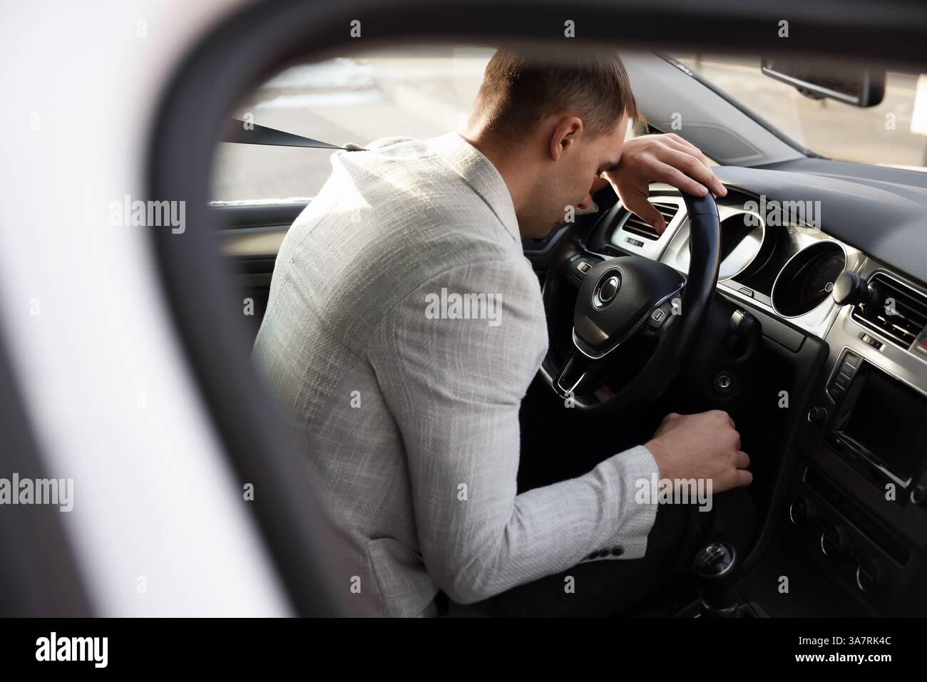 Tired driver sleeping on steering wheel in car, view from window Stock ...