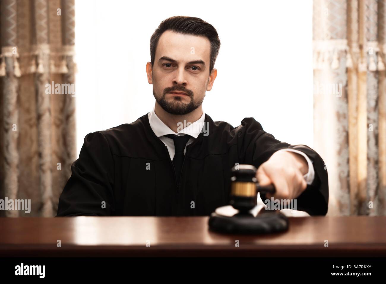 Judge striking gavel at table in courtroom Stock Photo - Alamy