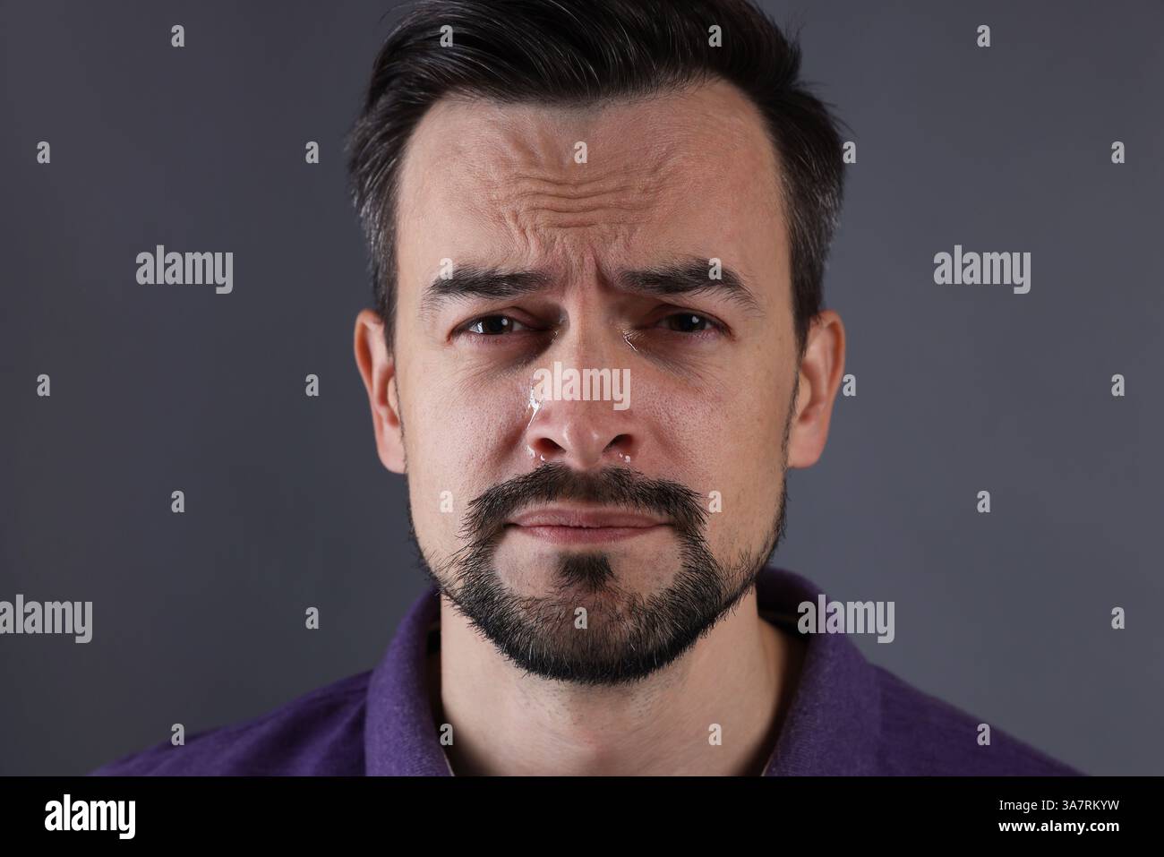 Portrait of sad man crying on grey background Stock Photo - Alamy