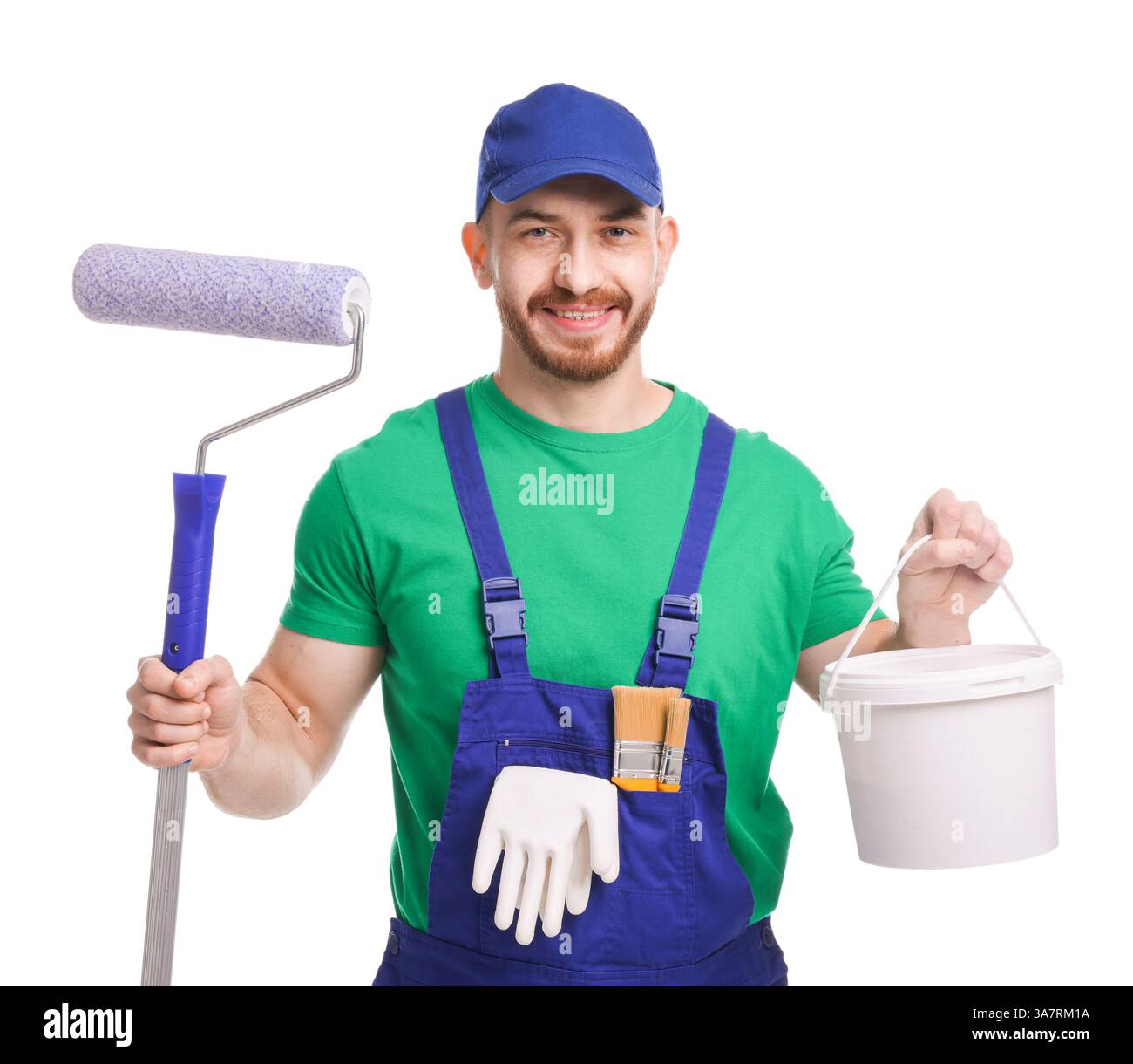 Professional painter with roller and bucket of paint on white ...