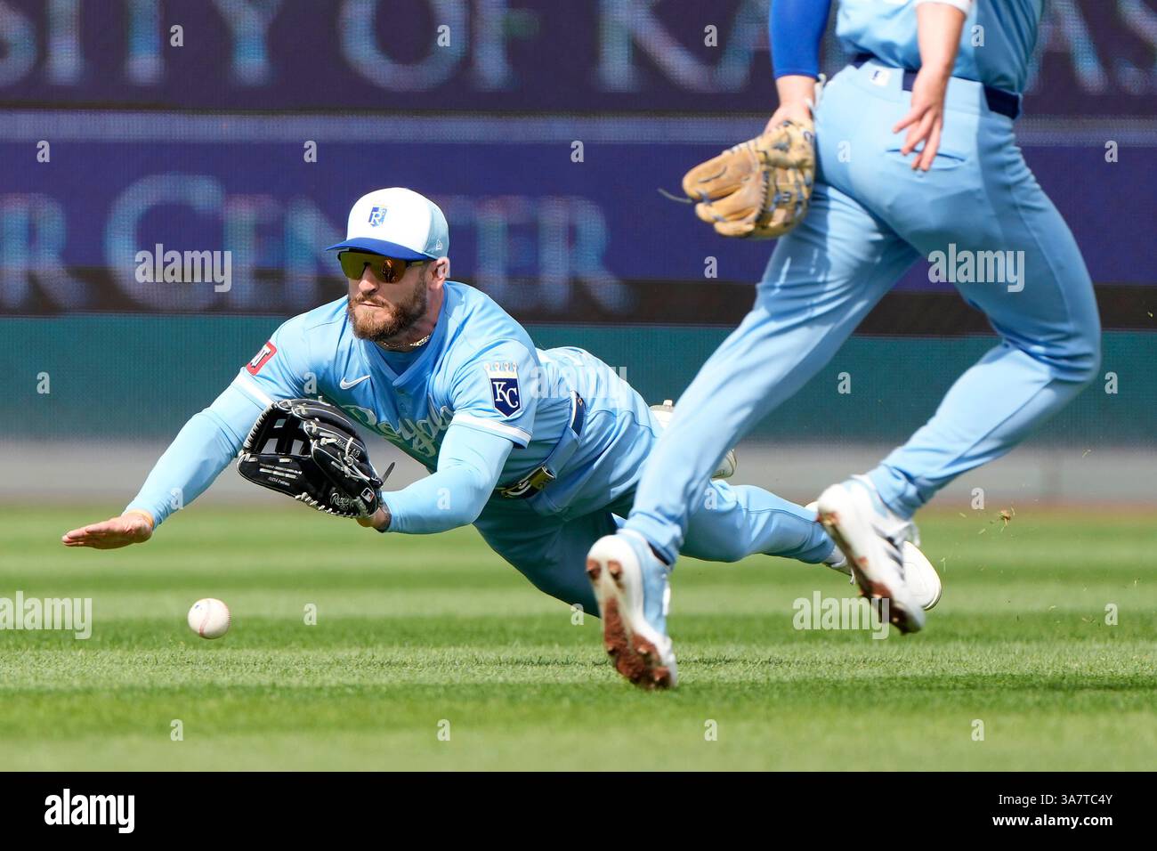 Kansas City Royals center fielder Kyle Isbel fields a single hit by ...