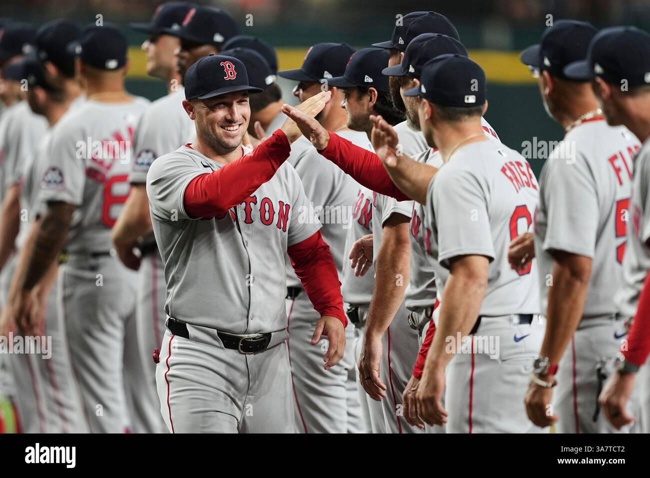 Boston Red Sox's Alex Bregma, left, is greeted by the team during ...