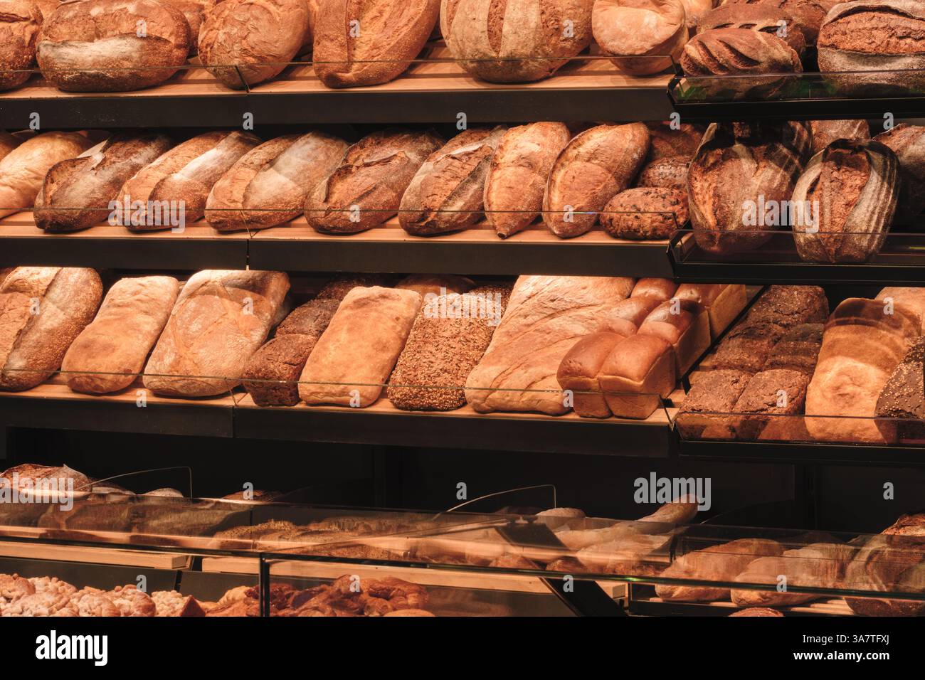 Breads on the shelf in the market or bakery. bakery with many different ...