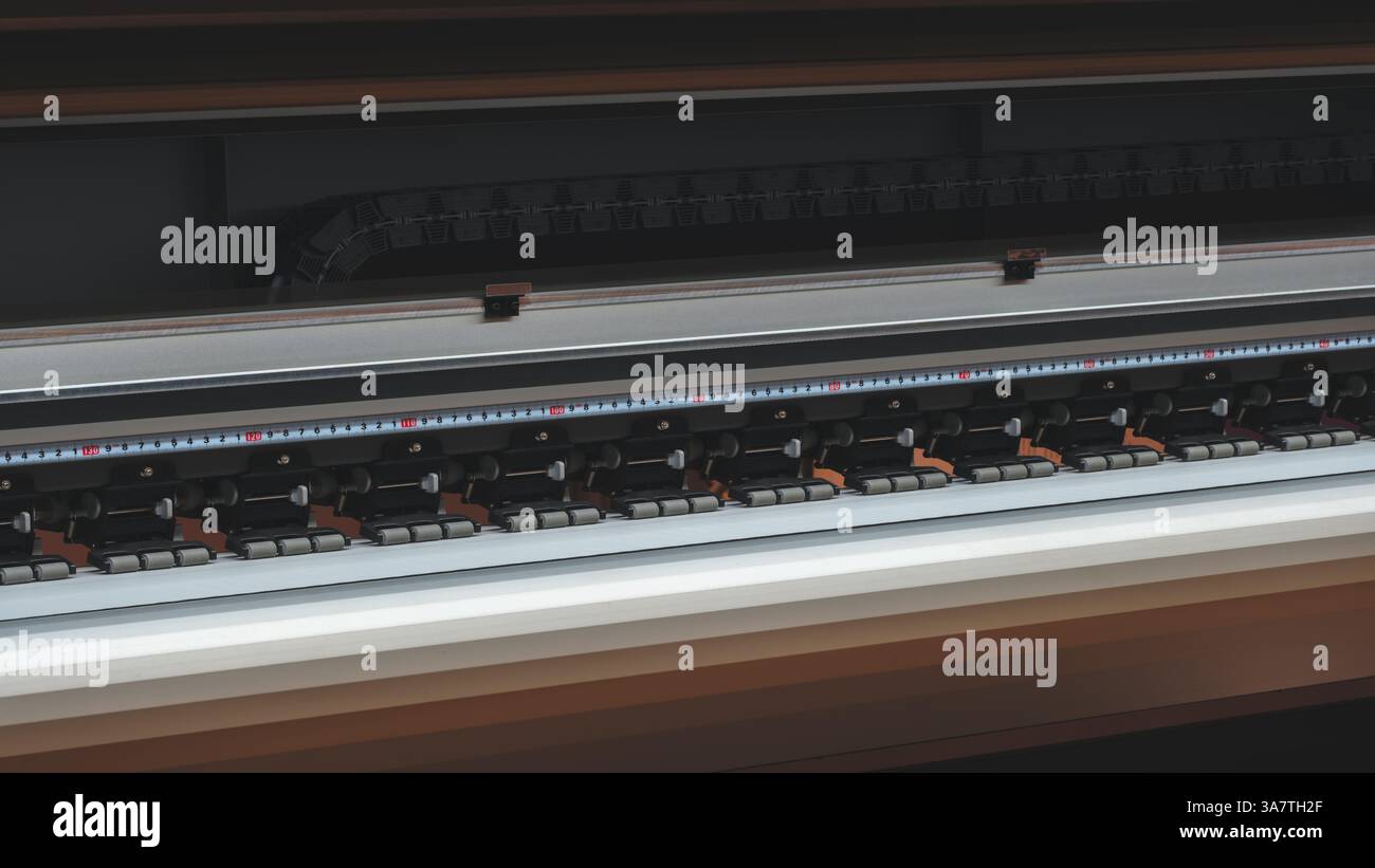 A printer with a ruler on it. The ruler is black and white and has ...