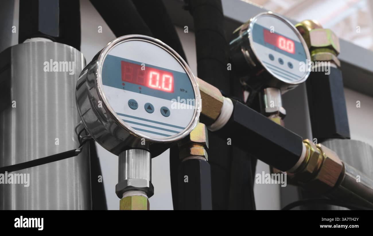 A digital pressure gauge is attached to a pipe Stock Photo - Alamy