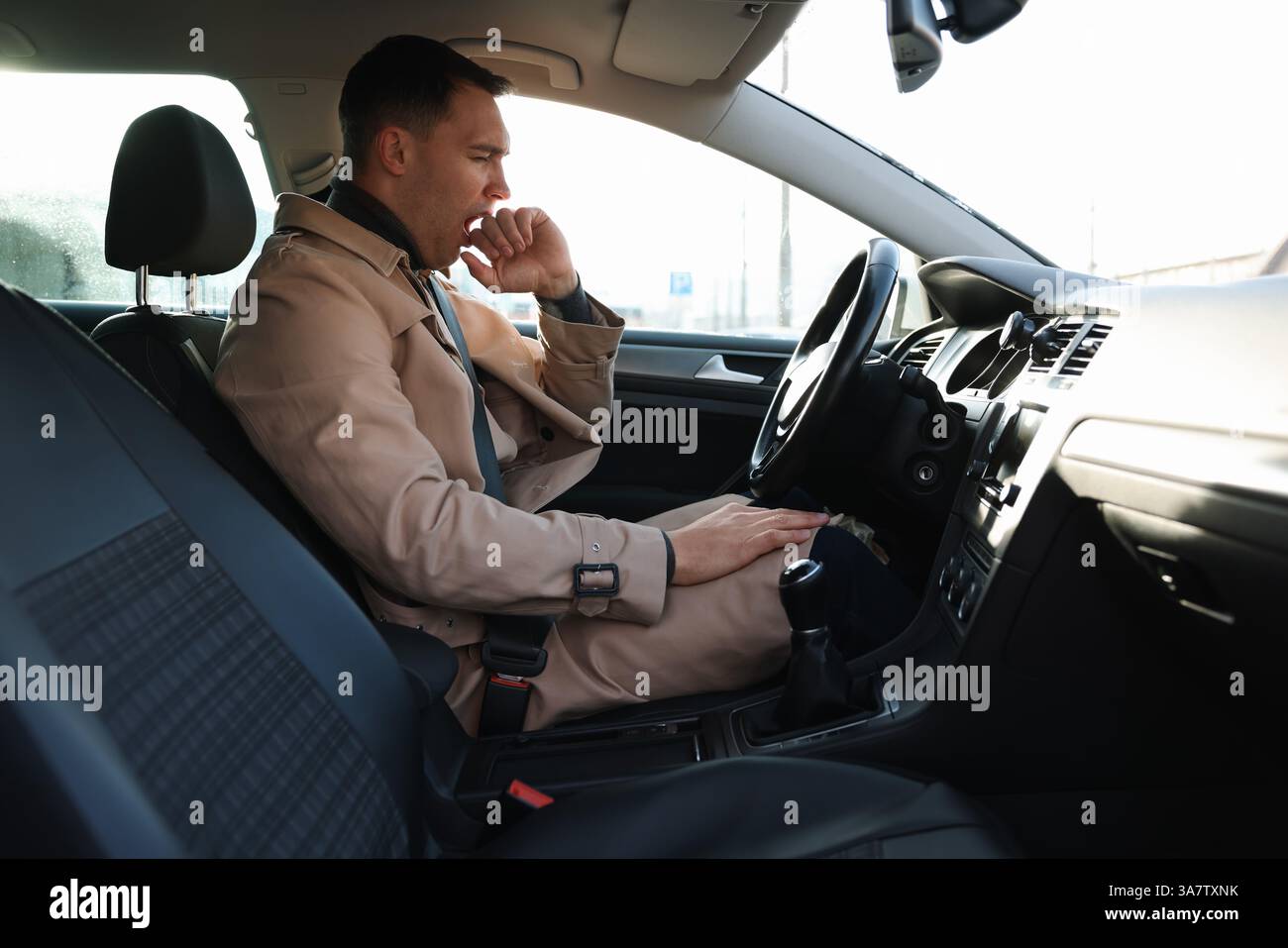Sleepy driver yawning in his modern car Stock Photo - Alamy
