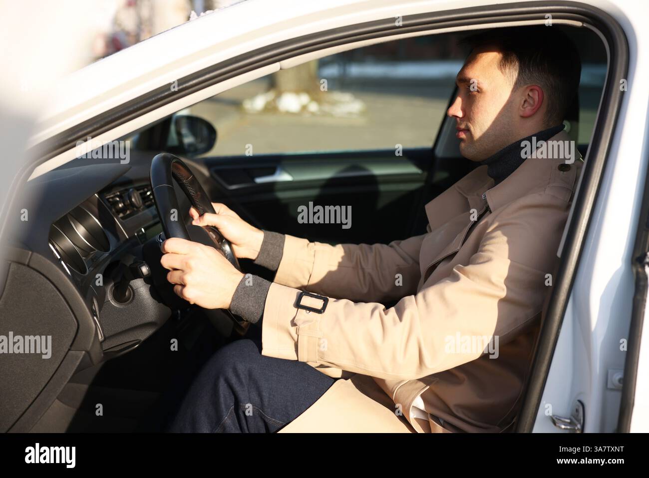 Driver behind steering wheel of modern car, view from outside Stock ...