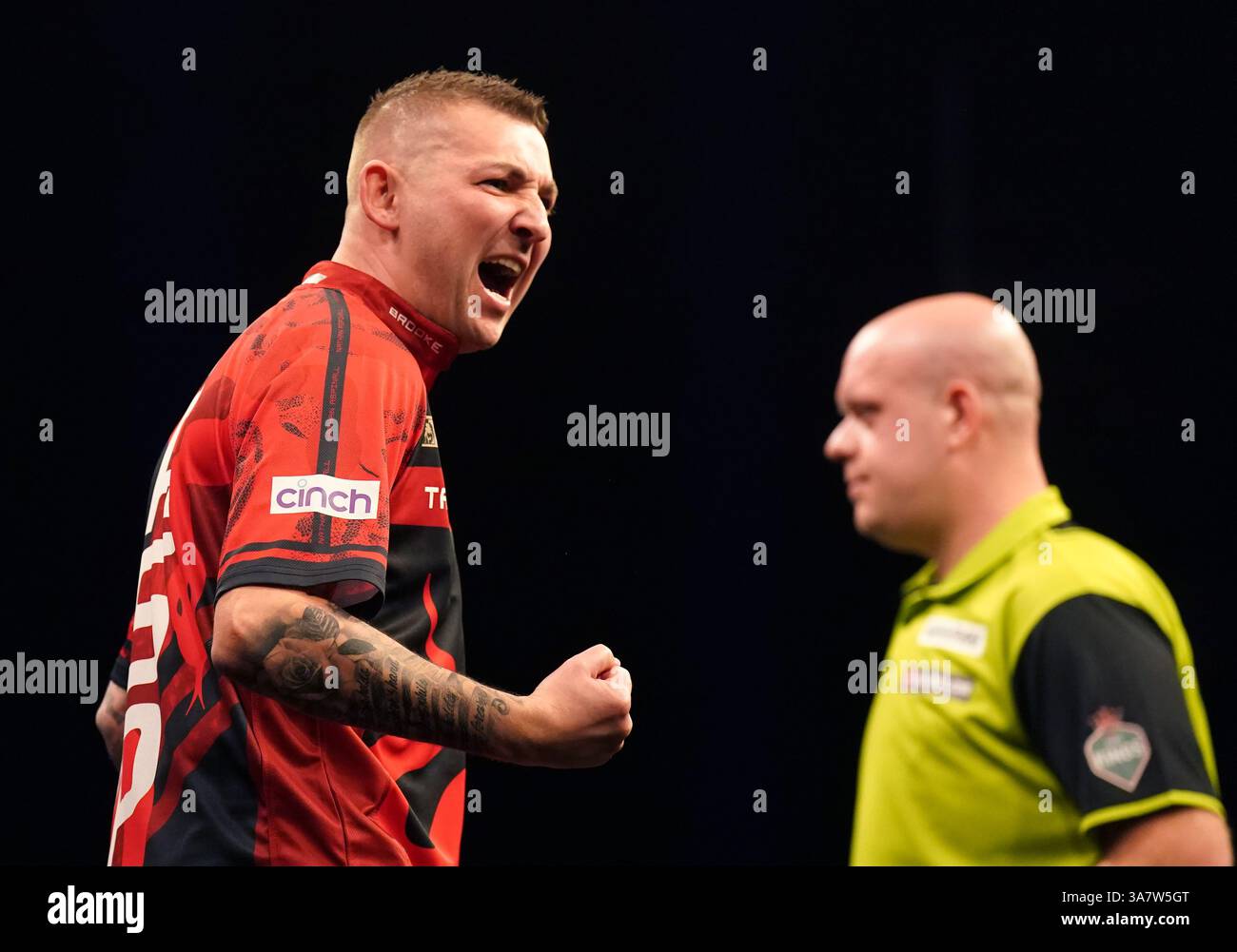Nathan Aspinall (left) celebrates victory against Michael van Gerwen on ...