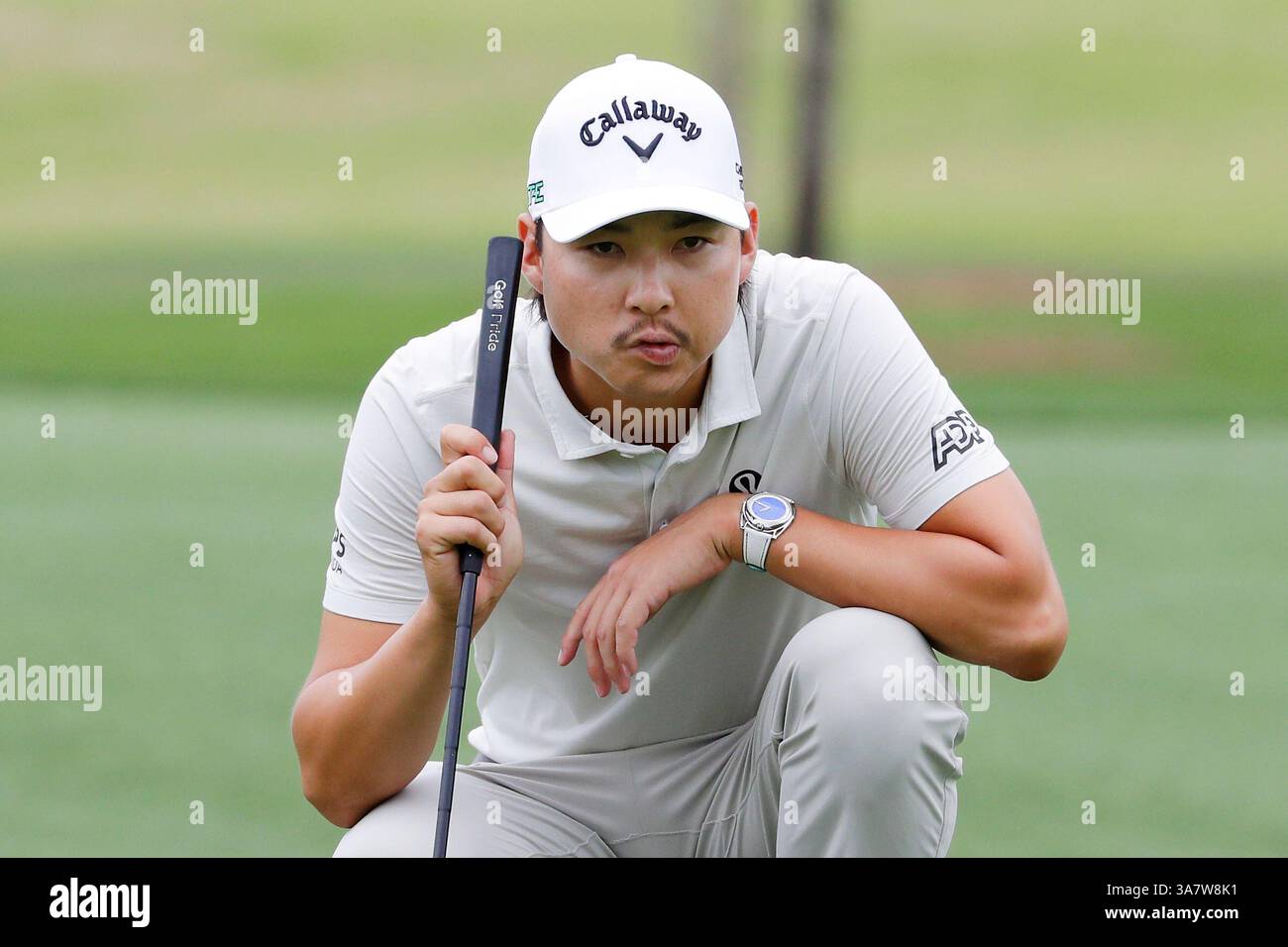 Min Woo Lee looks over the eighth green before putting in the first round of the Houston Open ...